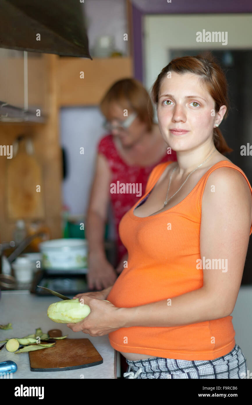 Two women cooks with vegetables in kitchen Stock Photo - Alamy