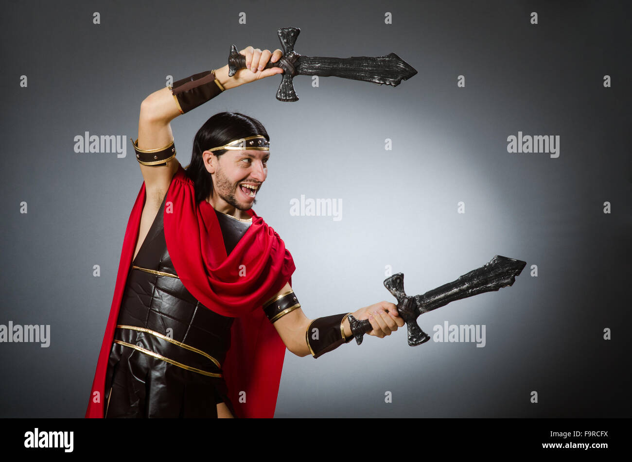 Roman warrior with sword against background Stock Photo - Alamy
