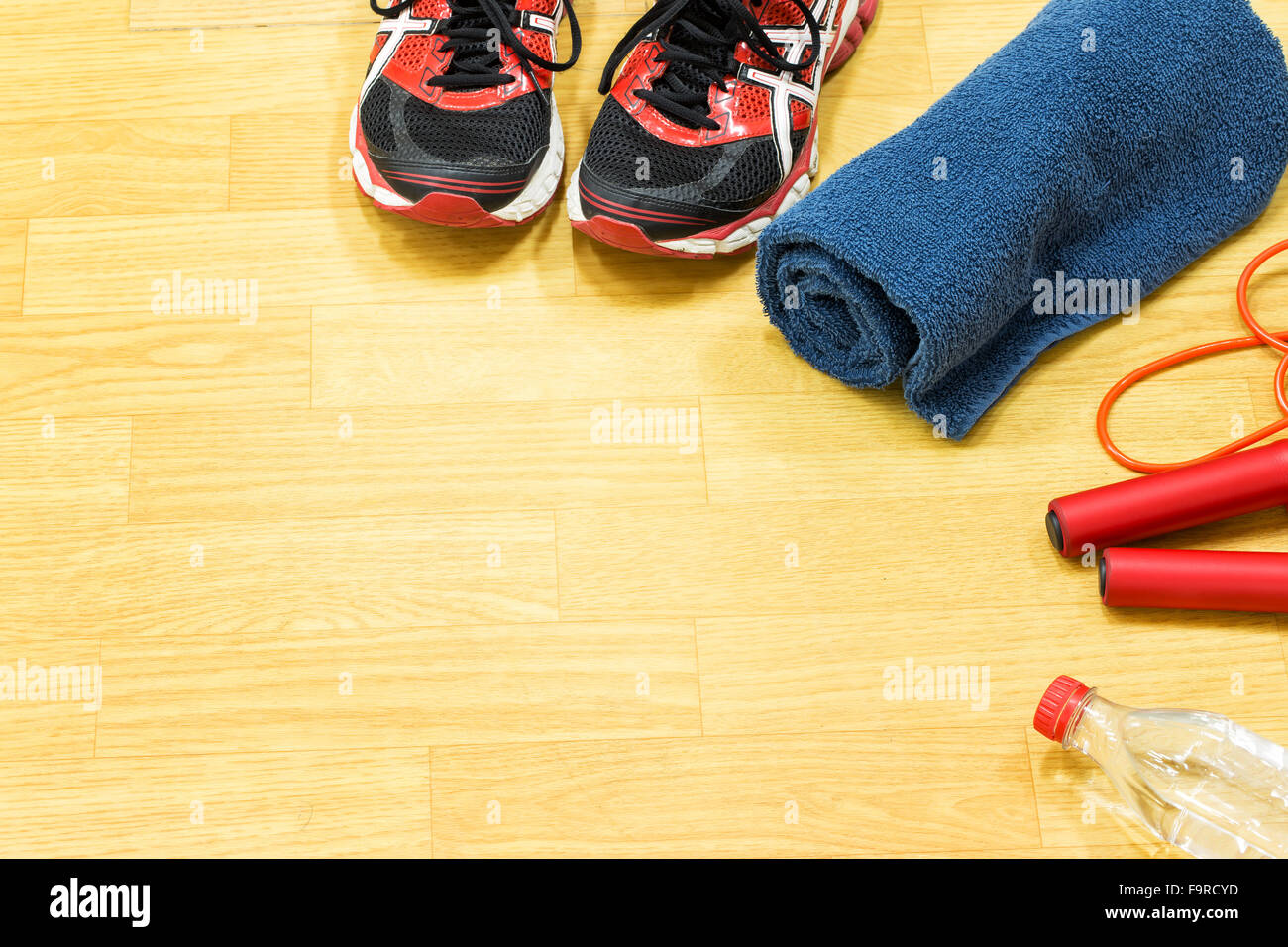 Sneakers, jump rope and water on pink gym floor Stock Photo - Alamy