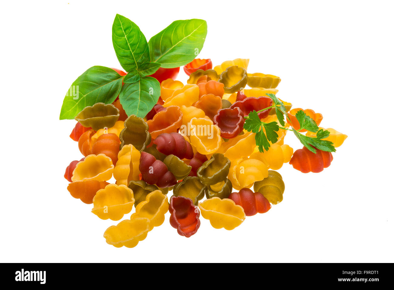 Raw macaroni variet color with basil Stock Photo - Alamy