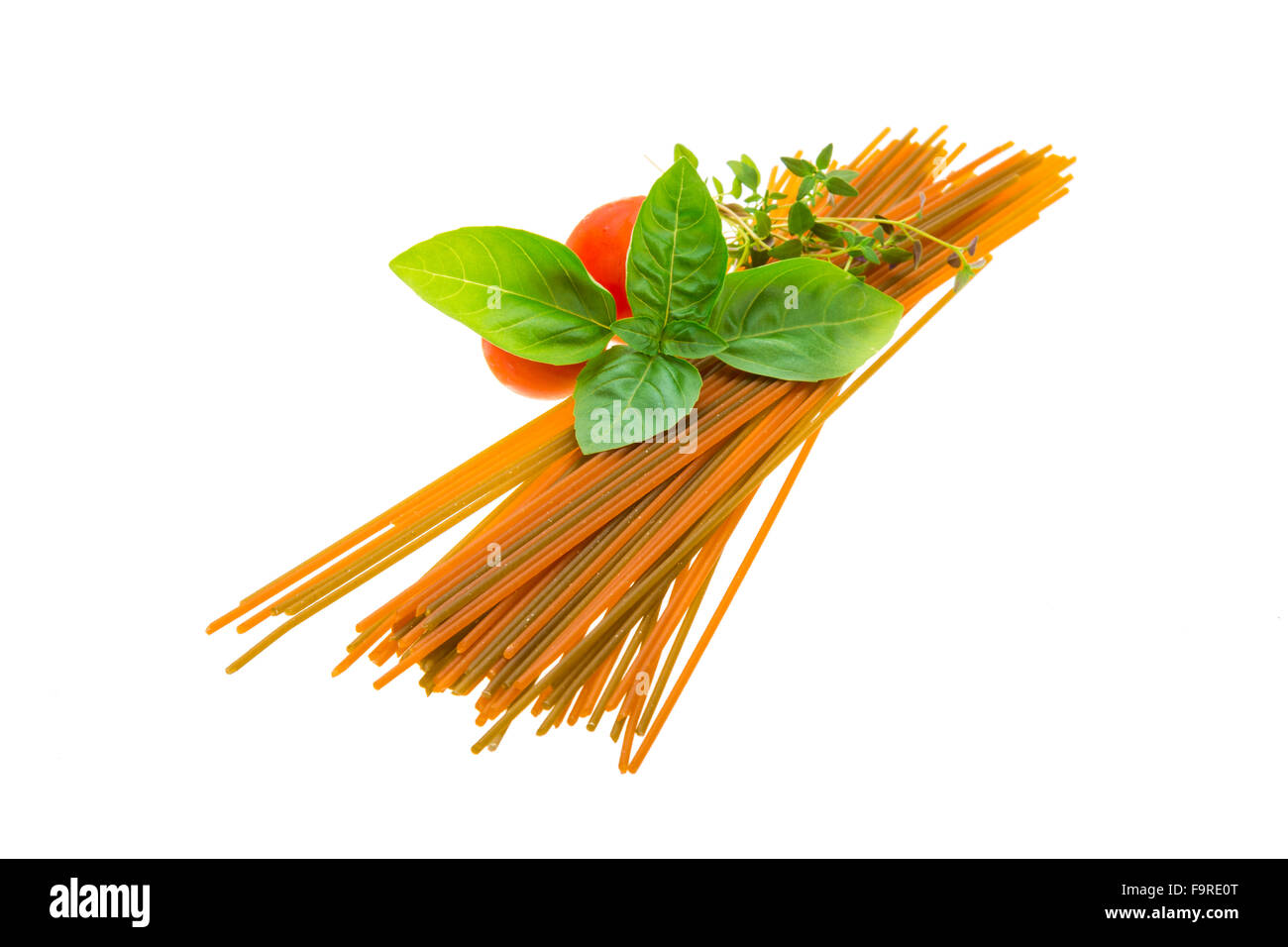 Color spaghetti with basil, thyme and tomato isolated Stock Photo - Alamy
