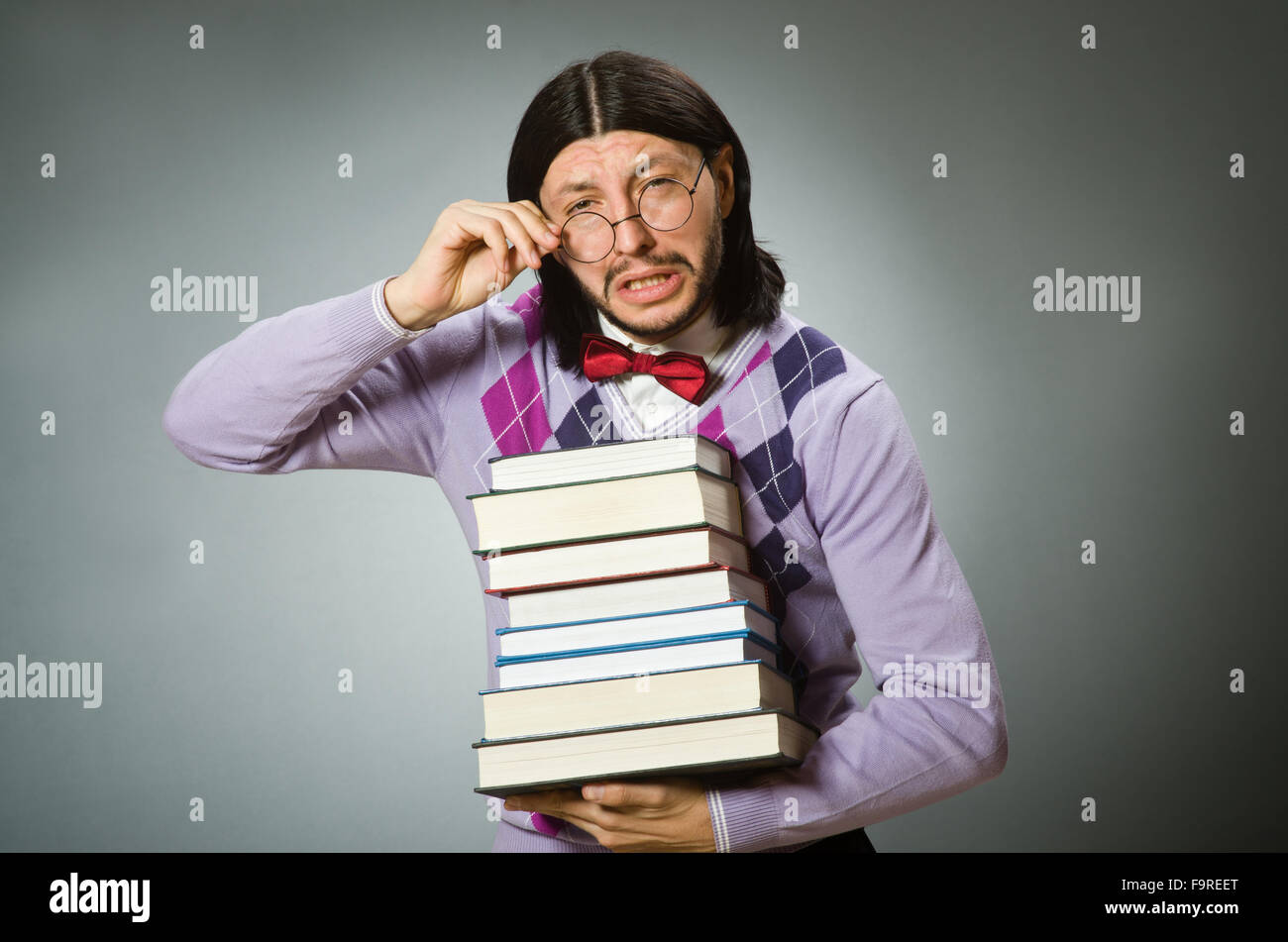 Young student with book in learning concept Stock Photo - Alamy