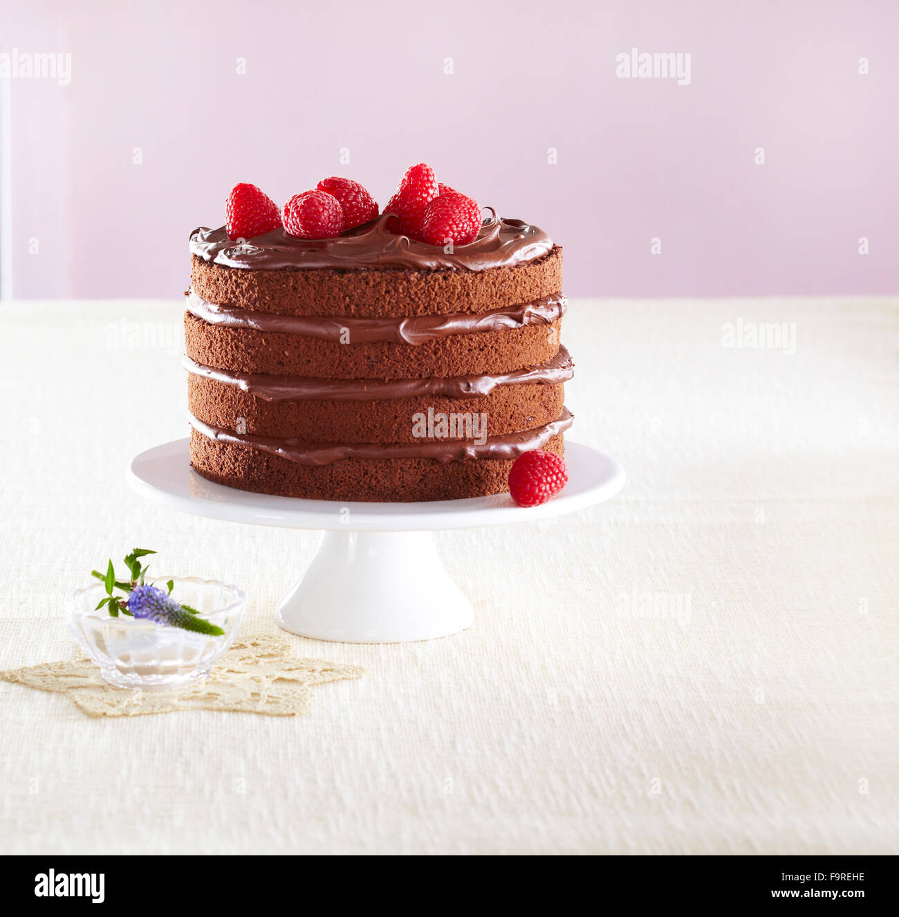 Layered chocolate cake with raspberries + steps Stock Photo - Alamy
