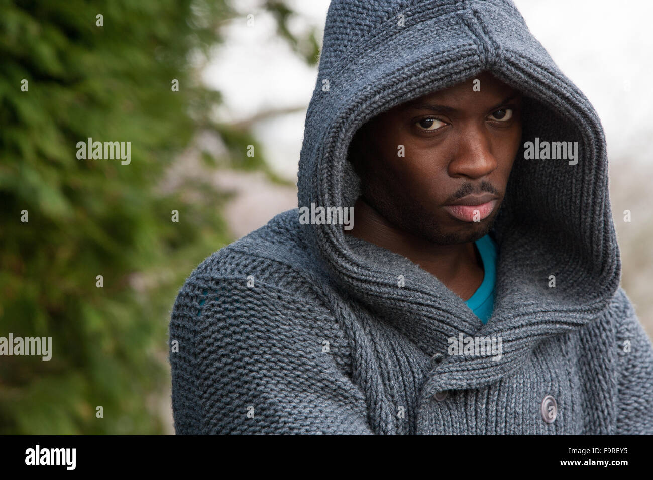Angry looking man with his hood up Stock Photo - Alamy