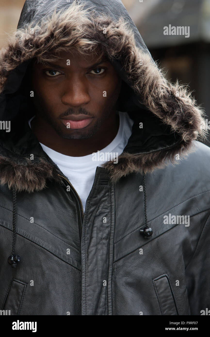 Angry looking man with his hood up Stock Photo - Alamy