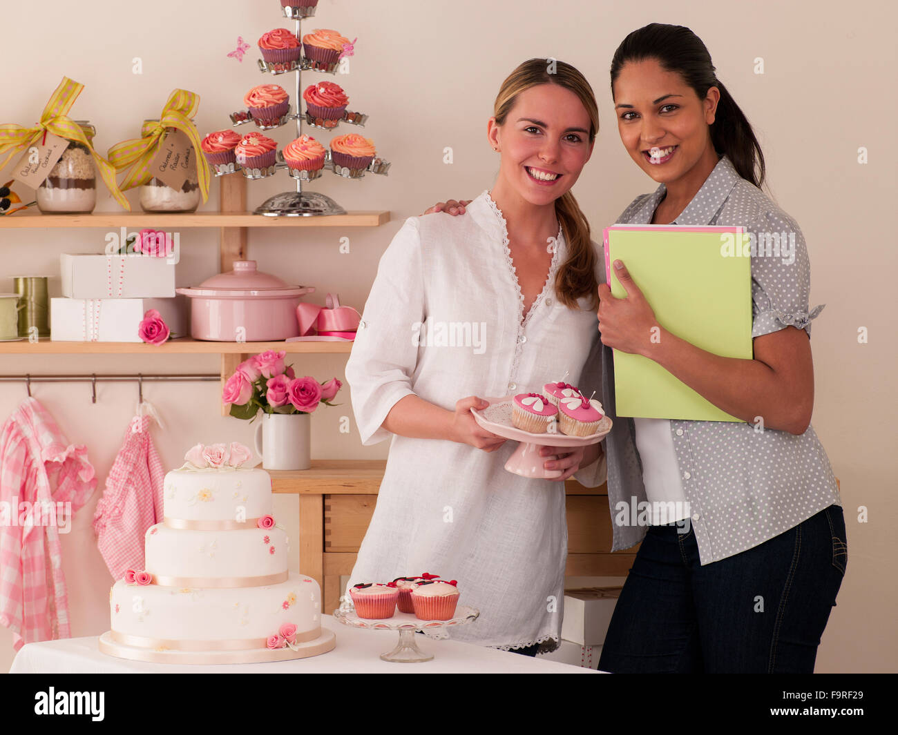 Two women making cakes for their bakery in a house Stock Photo - Alamy