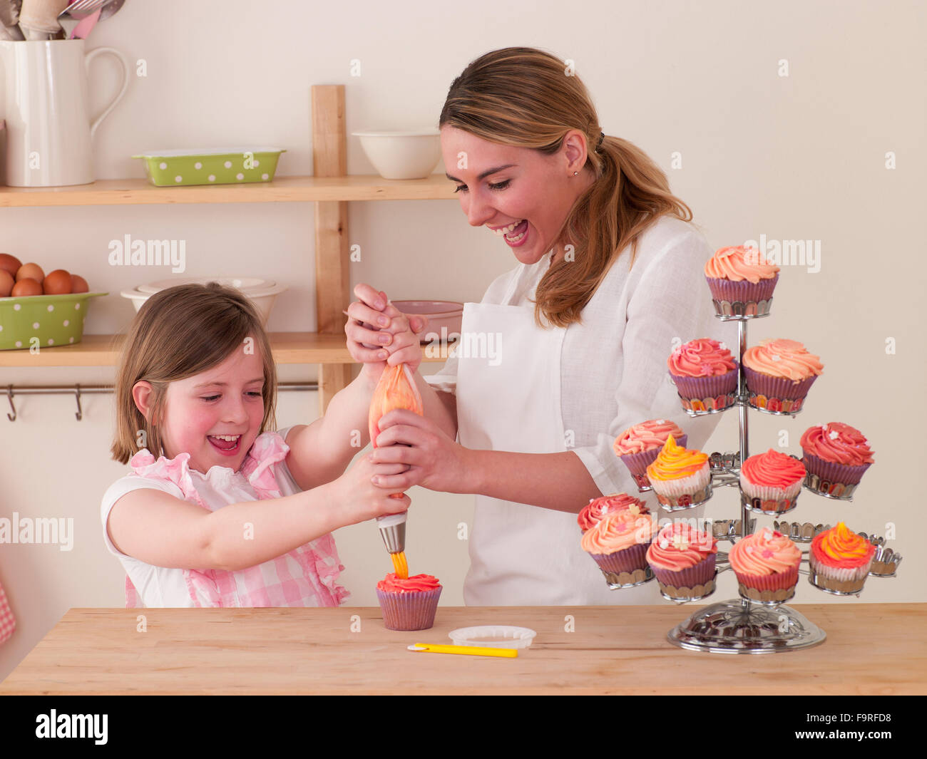 Mother and Daughter making cakes together Stock Photo - Alamy