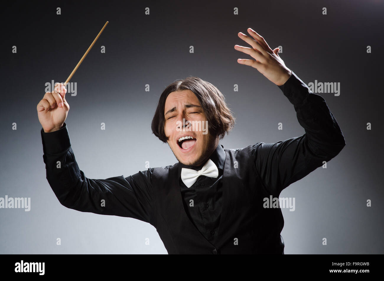 Funny conductor in musical concept Stock Photo - Alamy