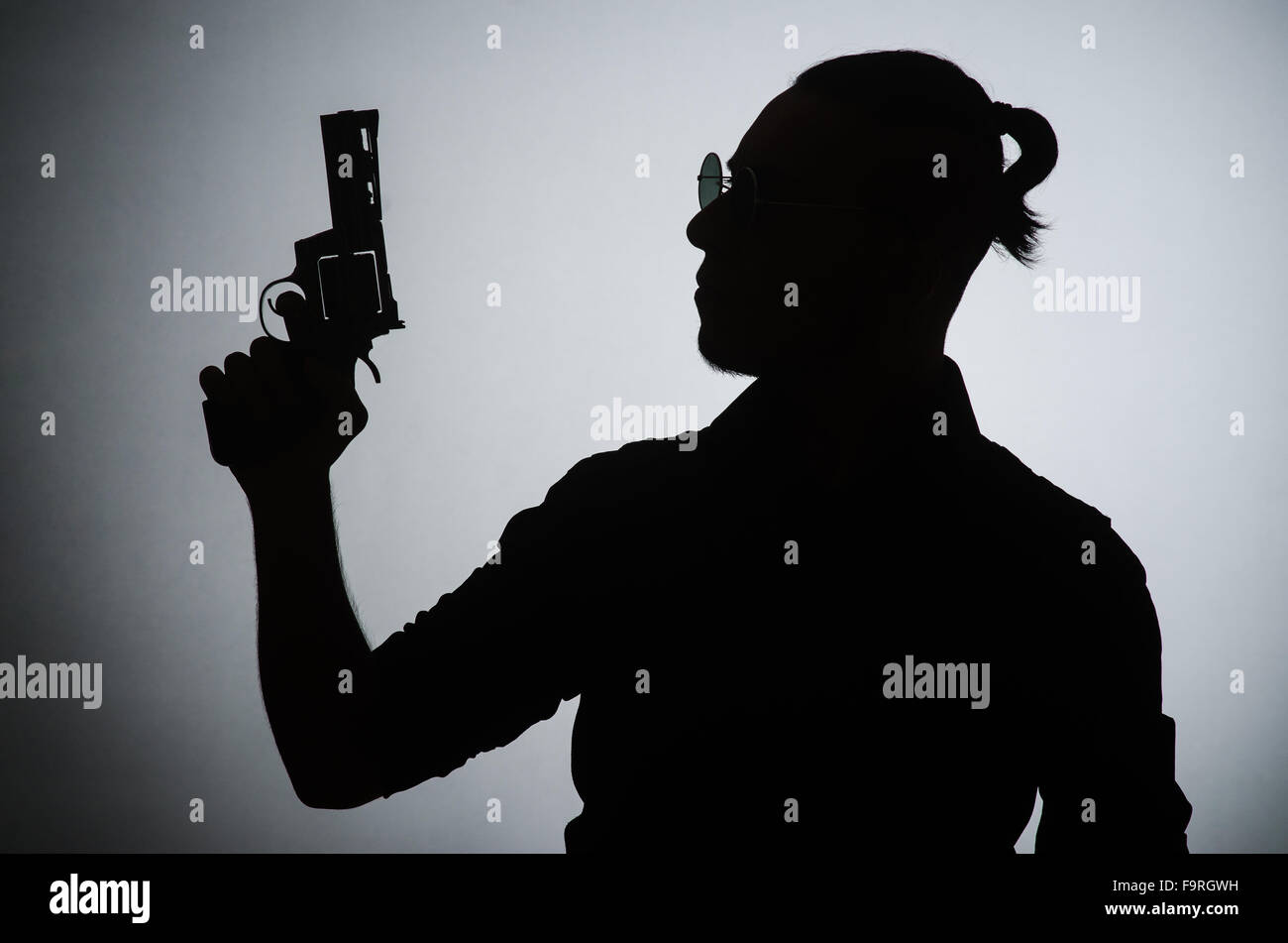 Shadow of the man with gun Stock Photo - Alamy