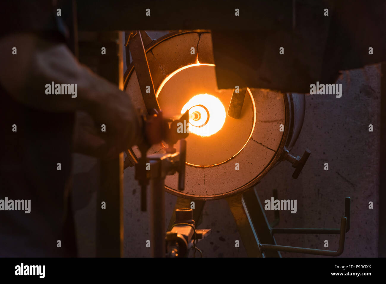 Melted glass, glowing red hot, in the melting furnace of the ...
