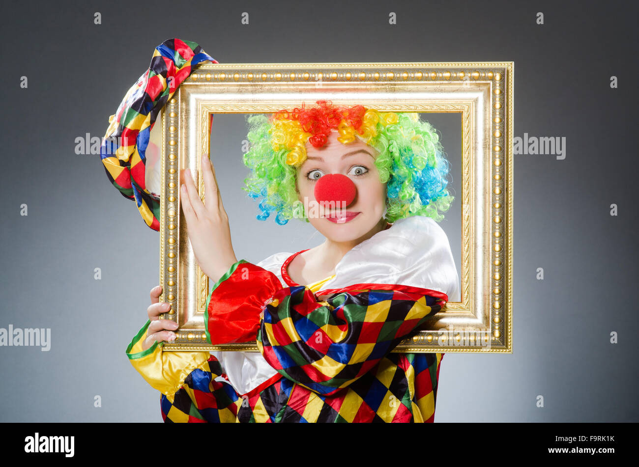 Clown with picture frame in funny concept Stock Photo - Alamy
