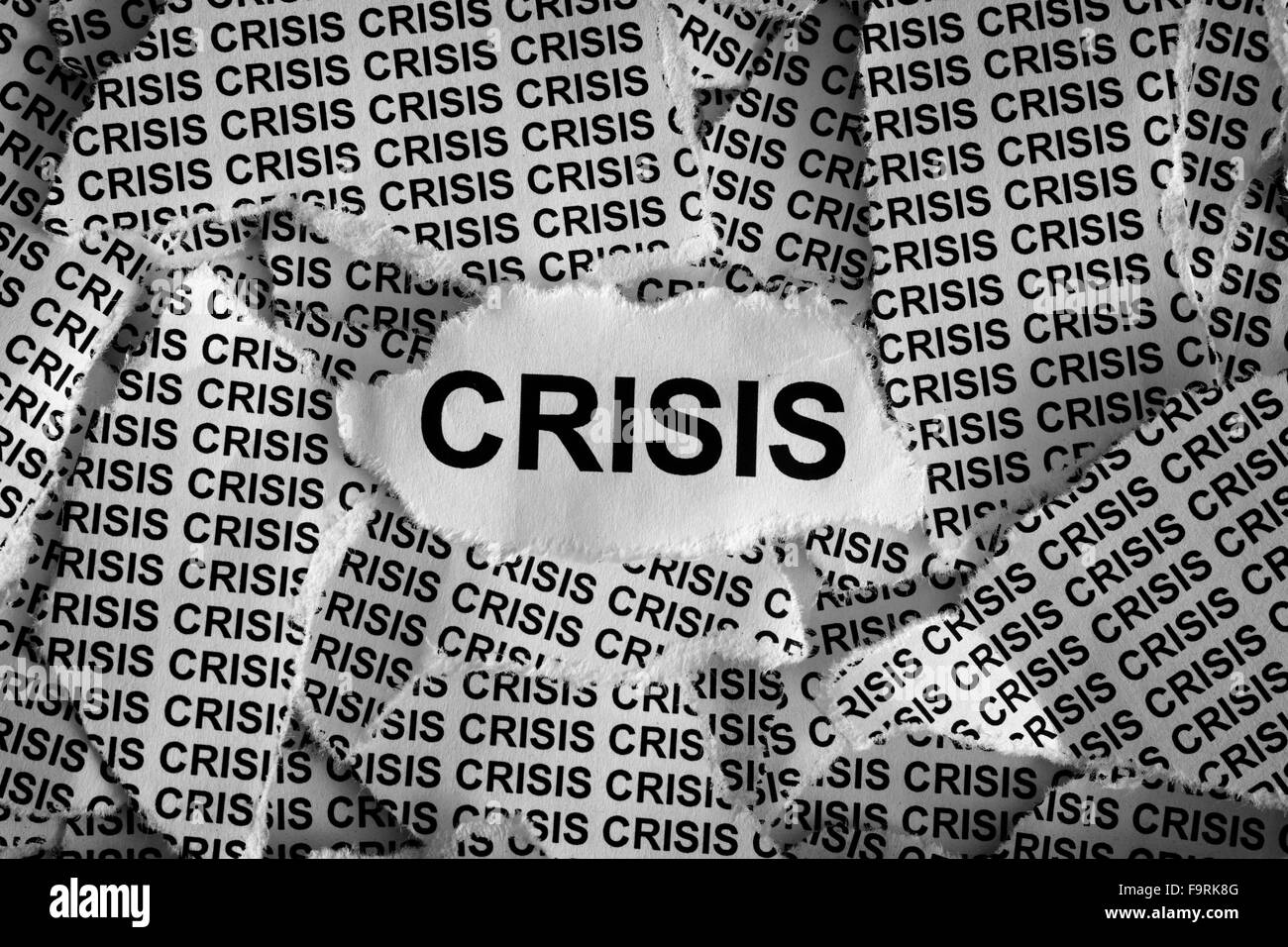 Torn pieces of paper with the word «Crisis». Black and White. Close-up ...