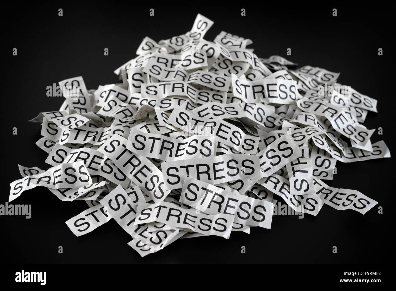 Crumpled paper pieces with word «Stress». Black background. Vignette ...