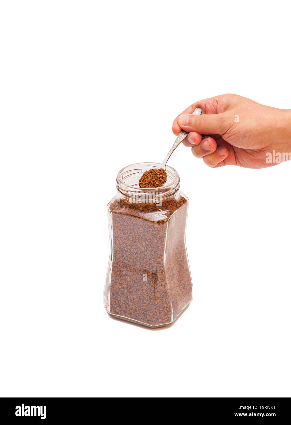 Open jar with instant coffee and hand with spoon Stock Photo - Alamy