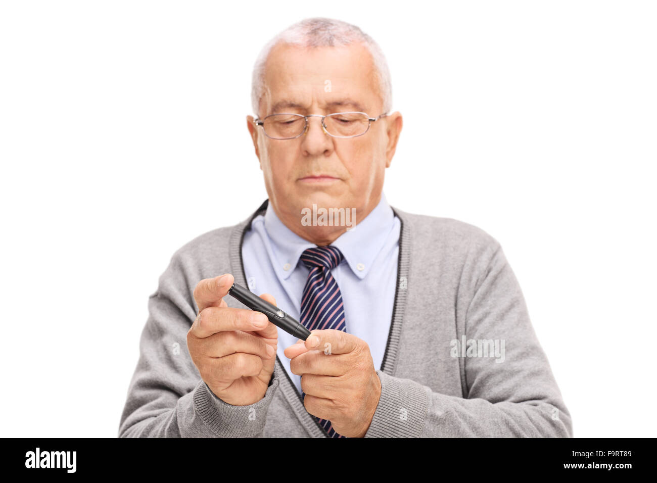 Senior gentleman measuring his blood sugar level with glucometer ...