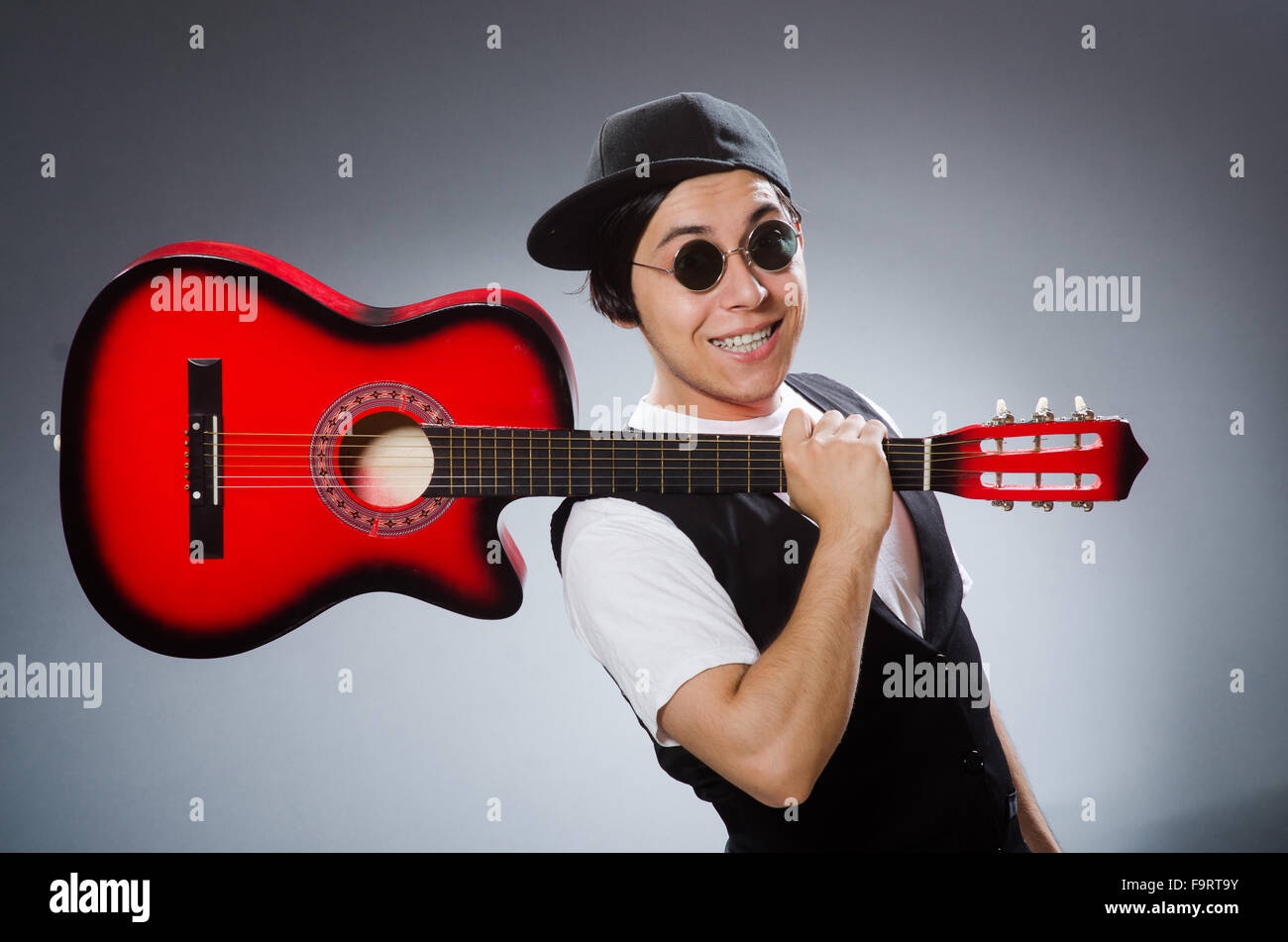 Funny guitar player in musical concept Stock Photo - Alamy