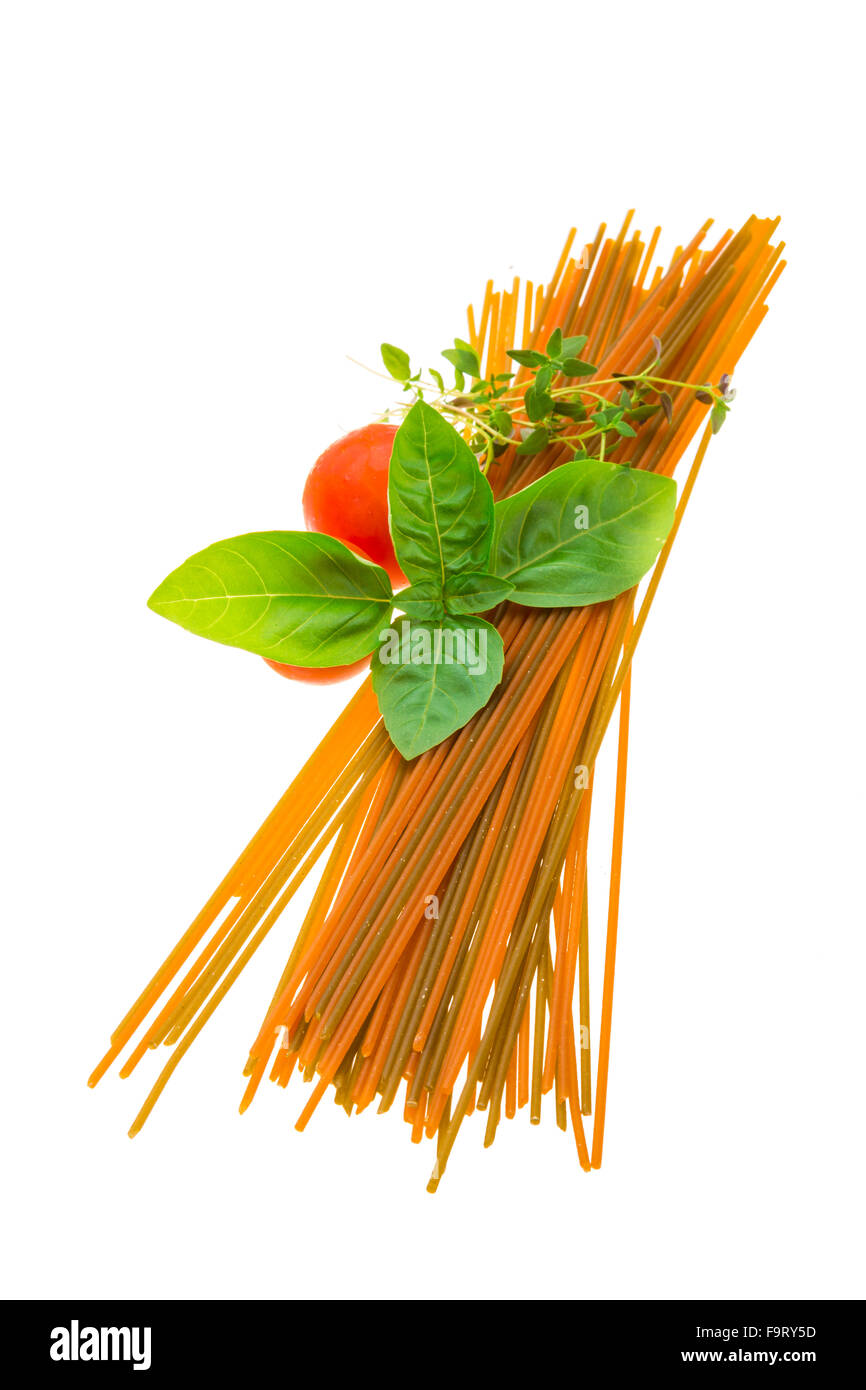Color spaghetti with basil, thyme and tomato isolated Stock Photo - Alamy