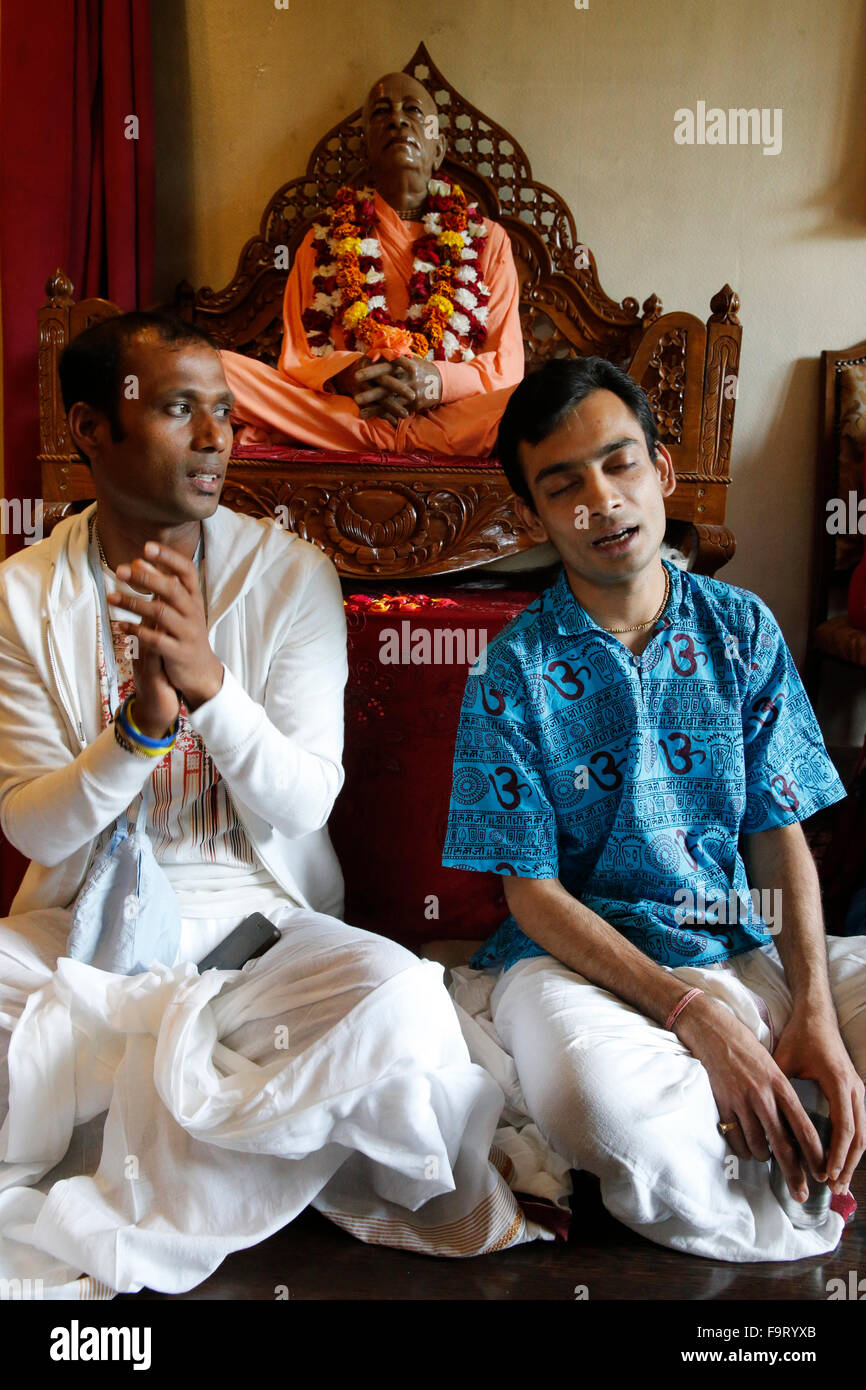 Faithful chanting in an ISKCON temple Stock Photo - Alamy