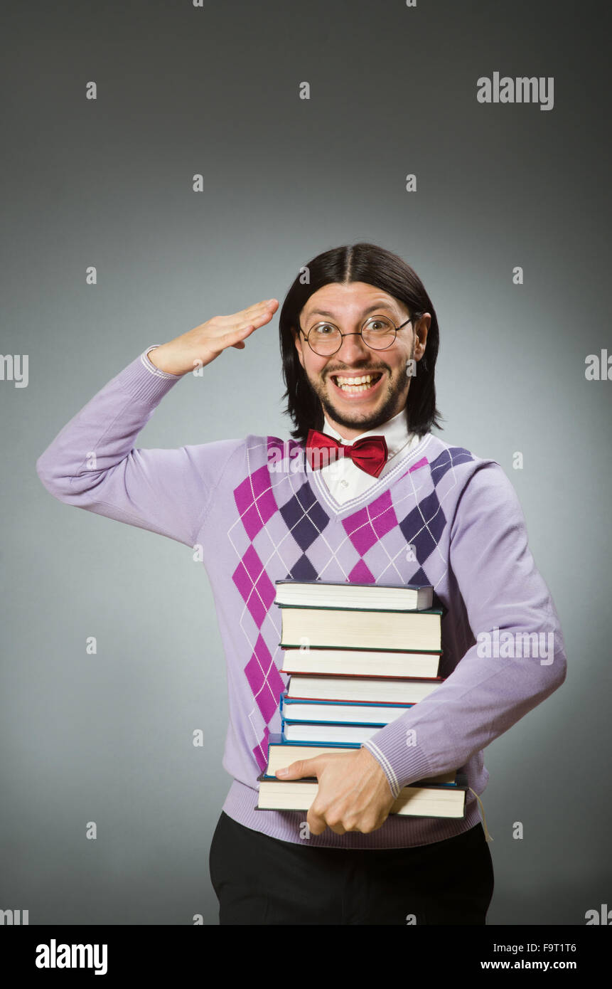 Young student with book in learning concept Stock Photo - Alamy