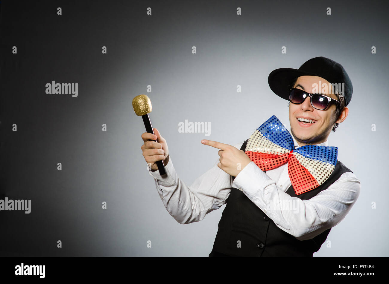 Funny man with mic in karaoke concept Stock Photo - Alamy