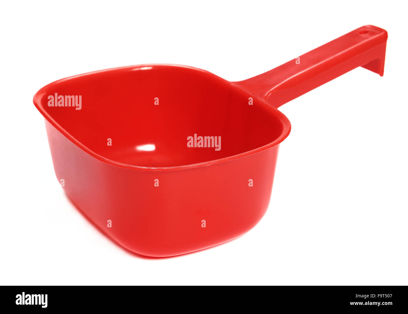 Plastic ladle of red on a white background Stock Photo - Alamy