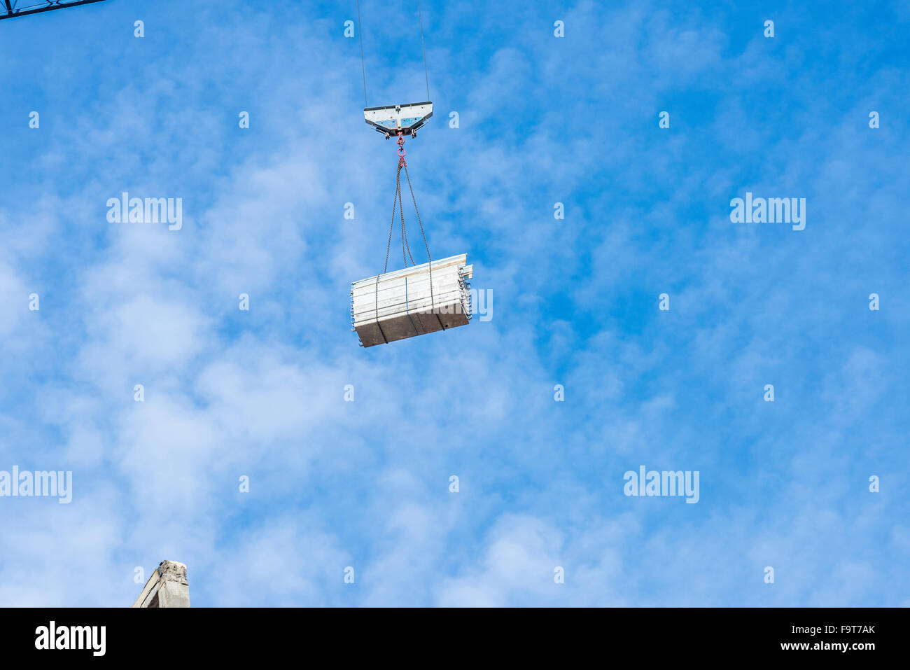 Crane lifting a lot of boards for building a skyscraper in Barcelona ...