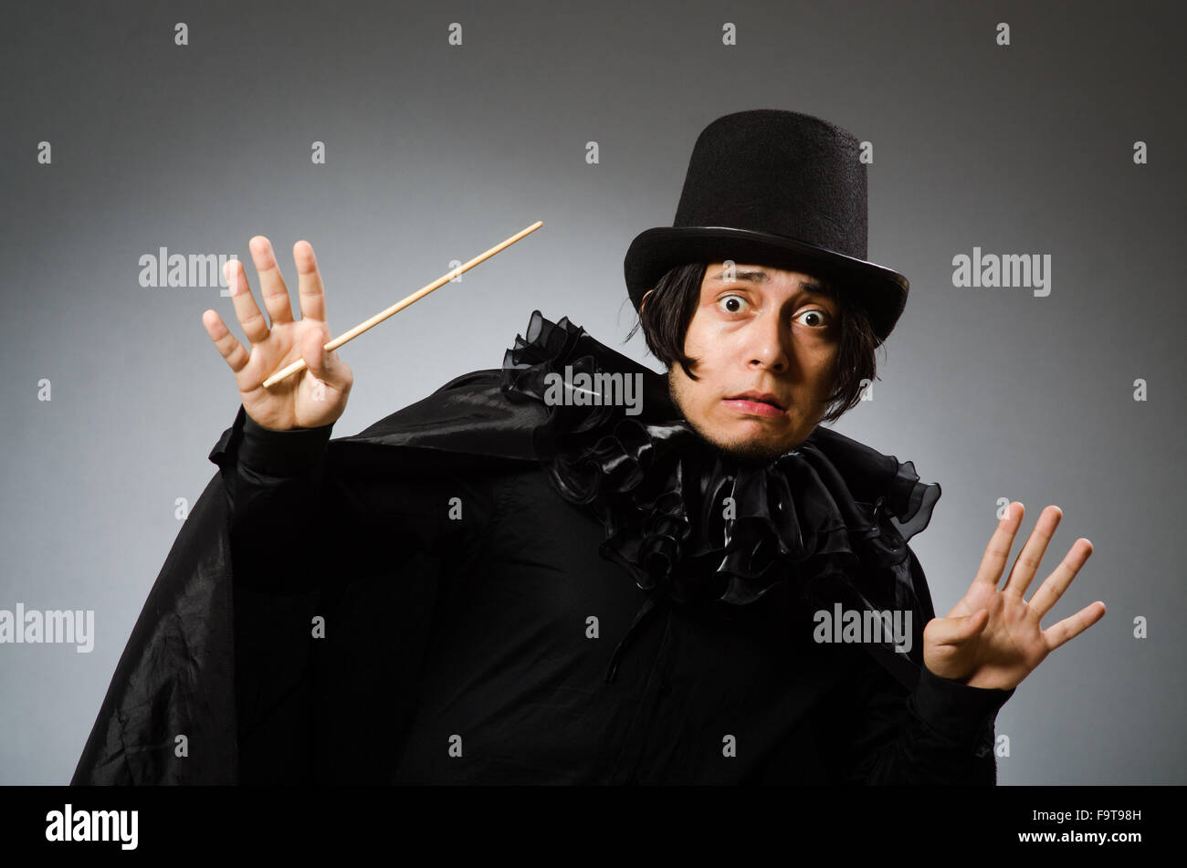 Funny magician wearing cylinder hat Stock Photo - Alamy