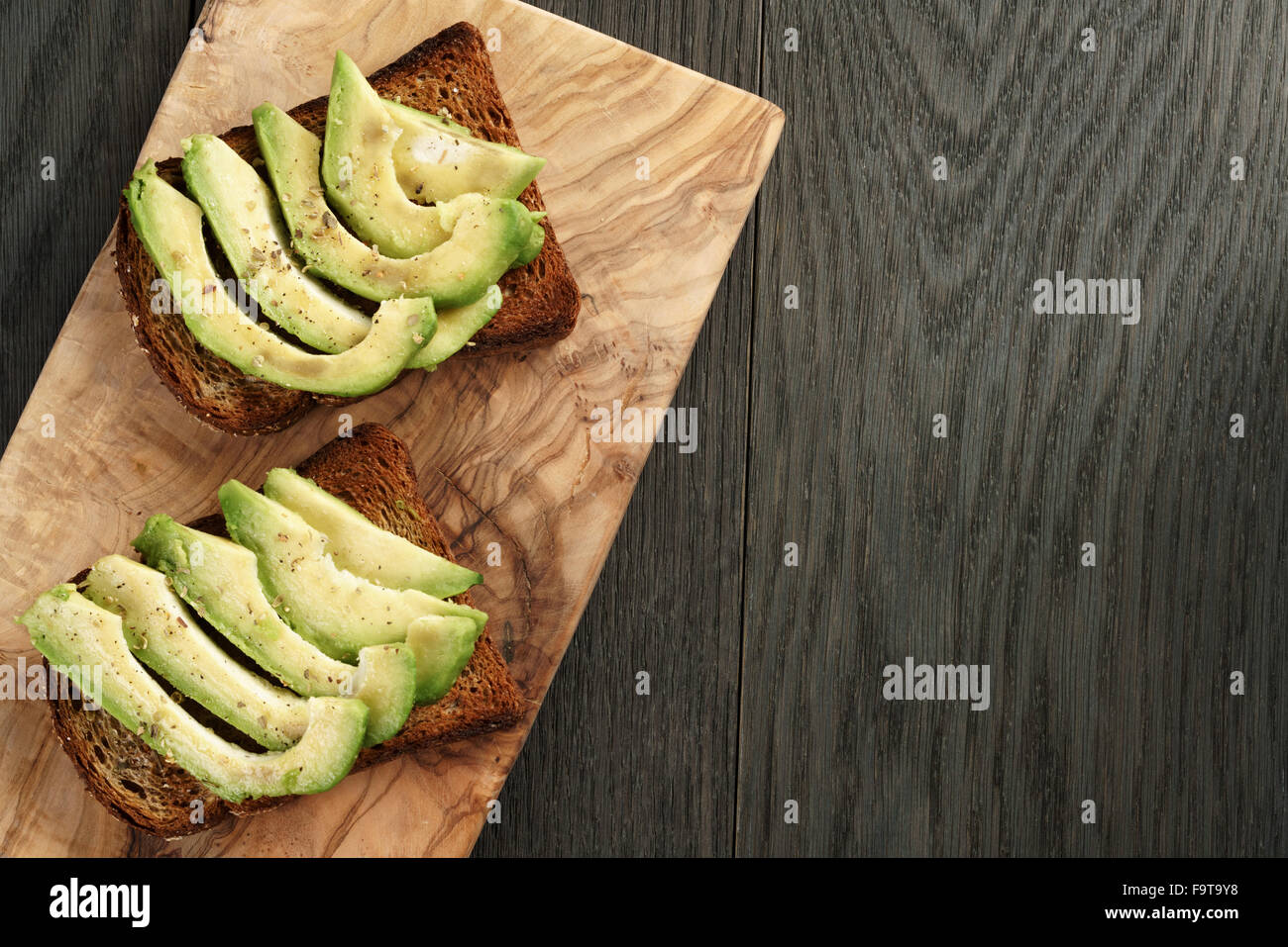toasted rye bread with sliced avocado and herbs Stock Photo - Alamy
