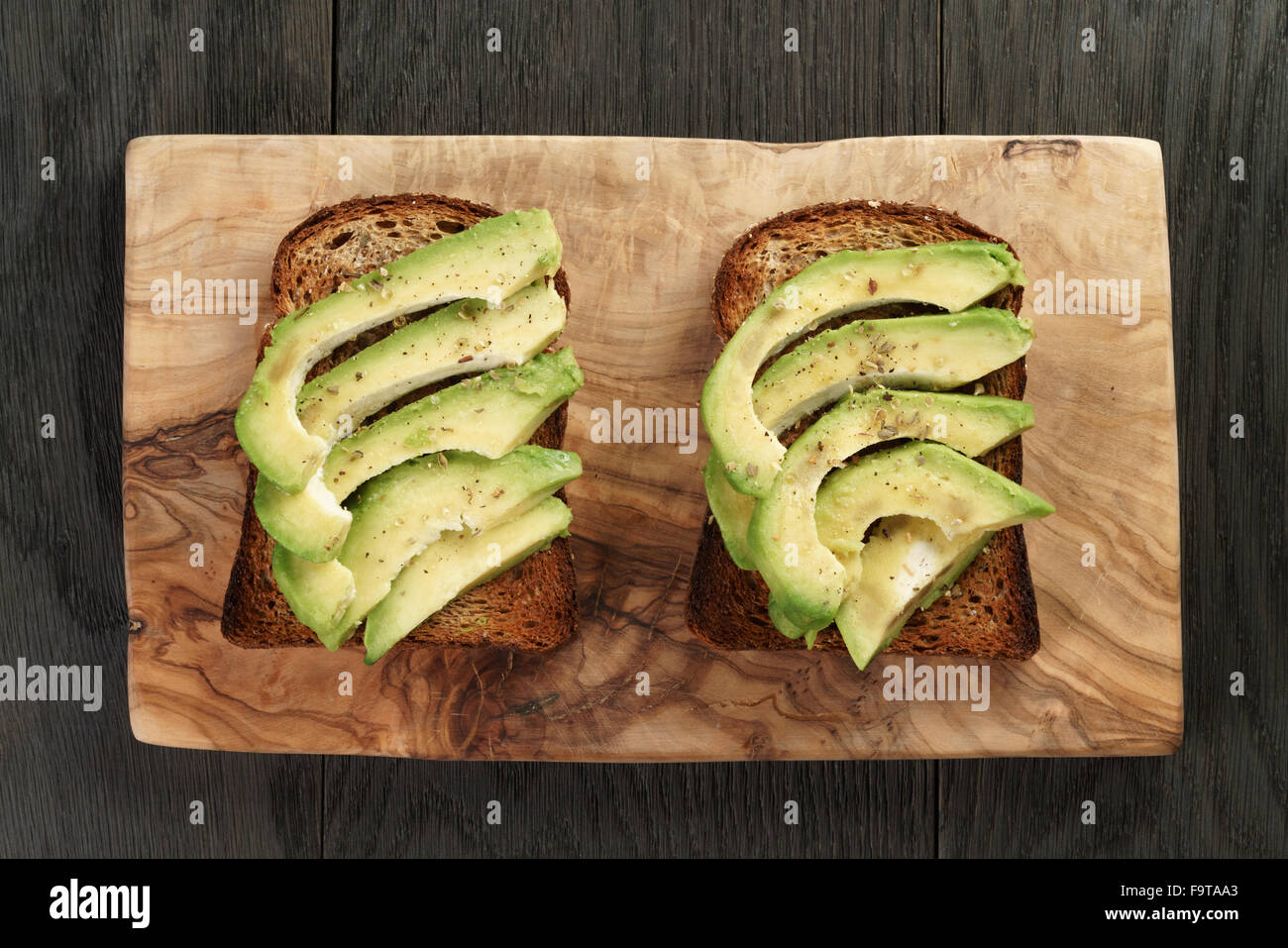 toasted rye bread with sliced avocado and herbs Stock Photo - Alamy