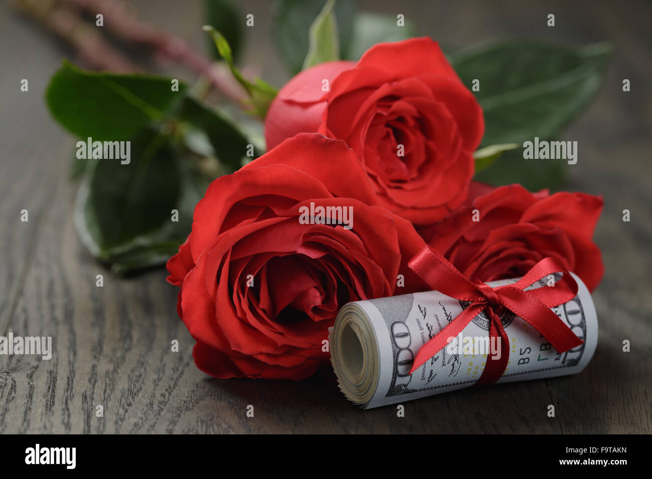 money roll with rose flower Stock Photo - Alamy