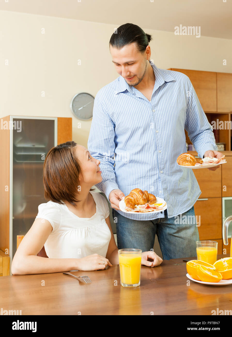 Young adult couple having breakfast in home interior Stock Photo - Alamy