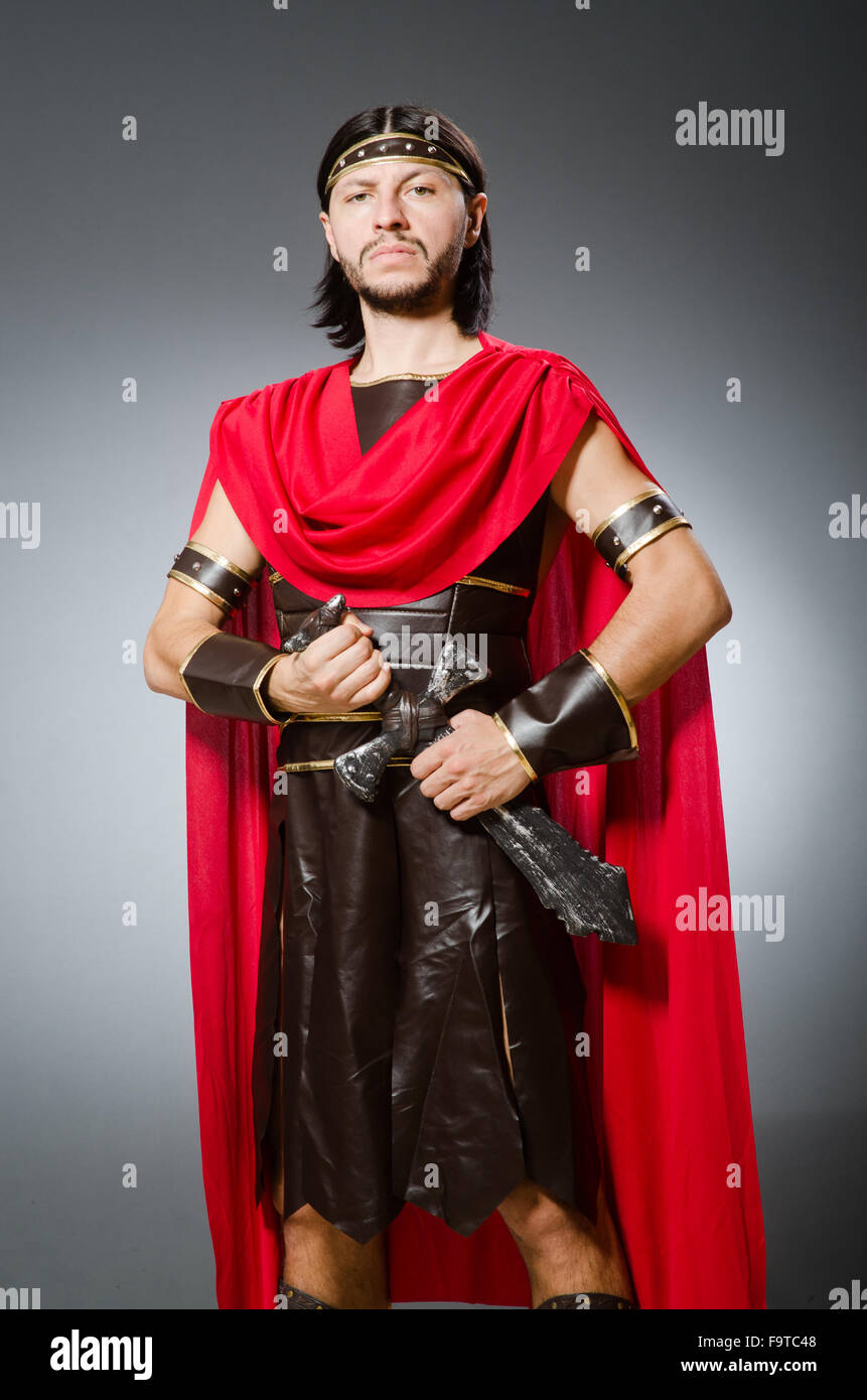 Roman warrior with sword against background Stock Photo - Alamy