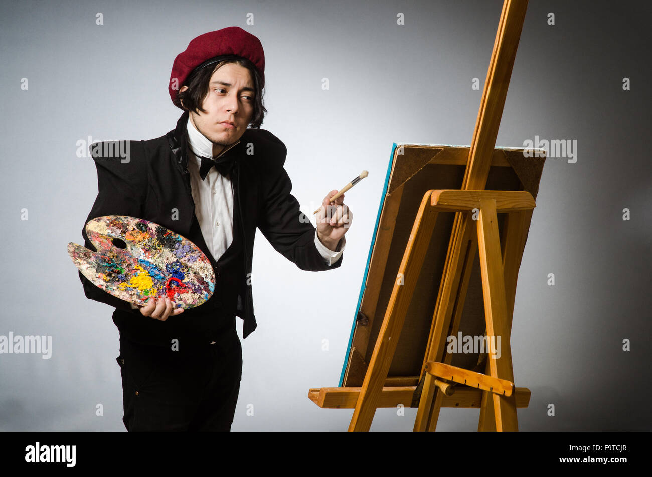 Funny artist in dark studio Stock Photo - Alamy