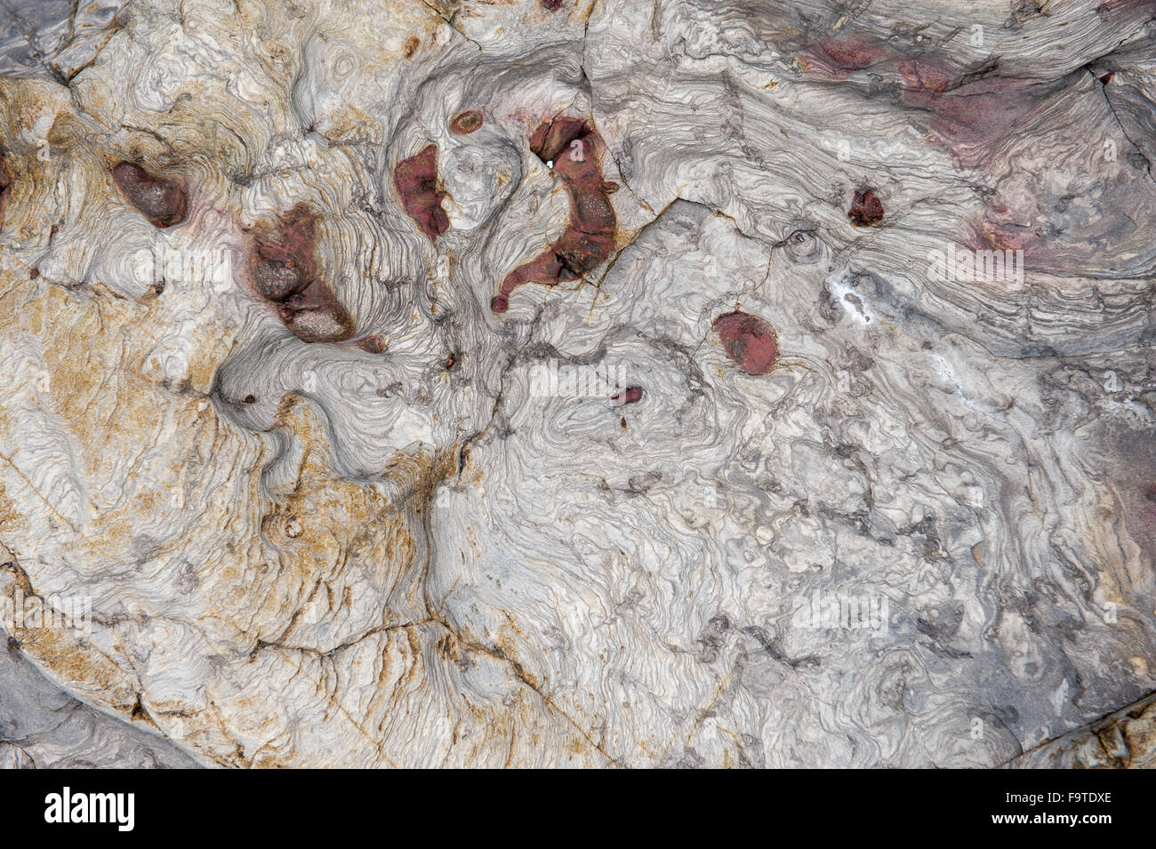 Natural metal seen in coastal stones Stock Photo - Alamy