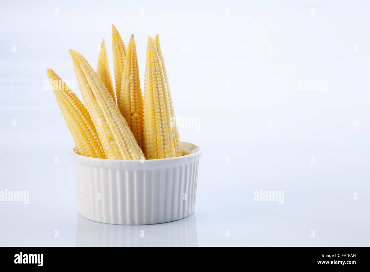 Baby corn on a white background, close-up Stock Photo - Alamy