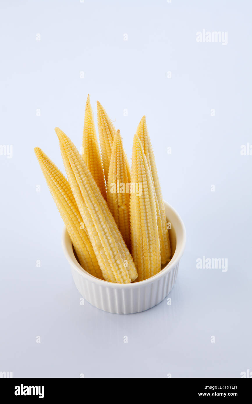 Baby corn on a white background, close-up Stock Photo - Alamy