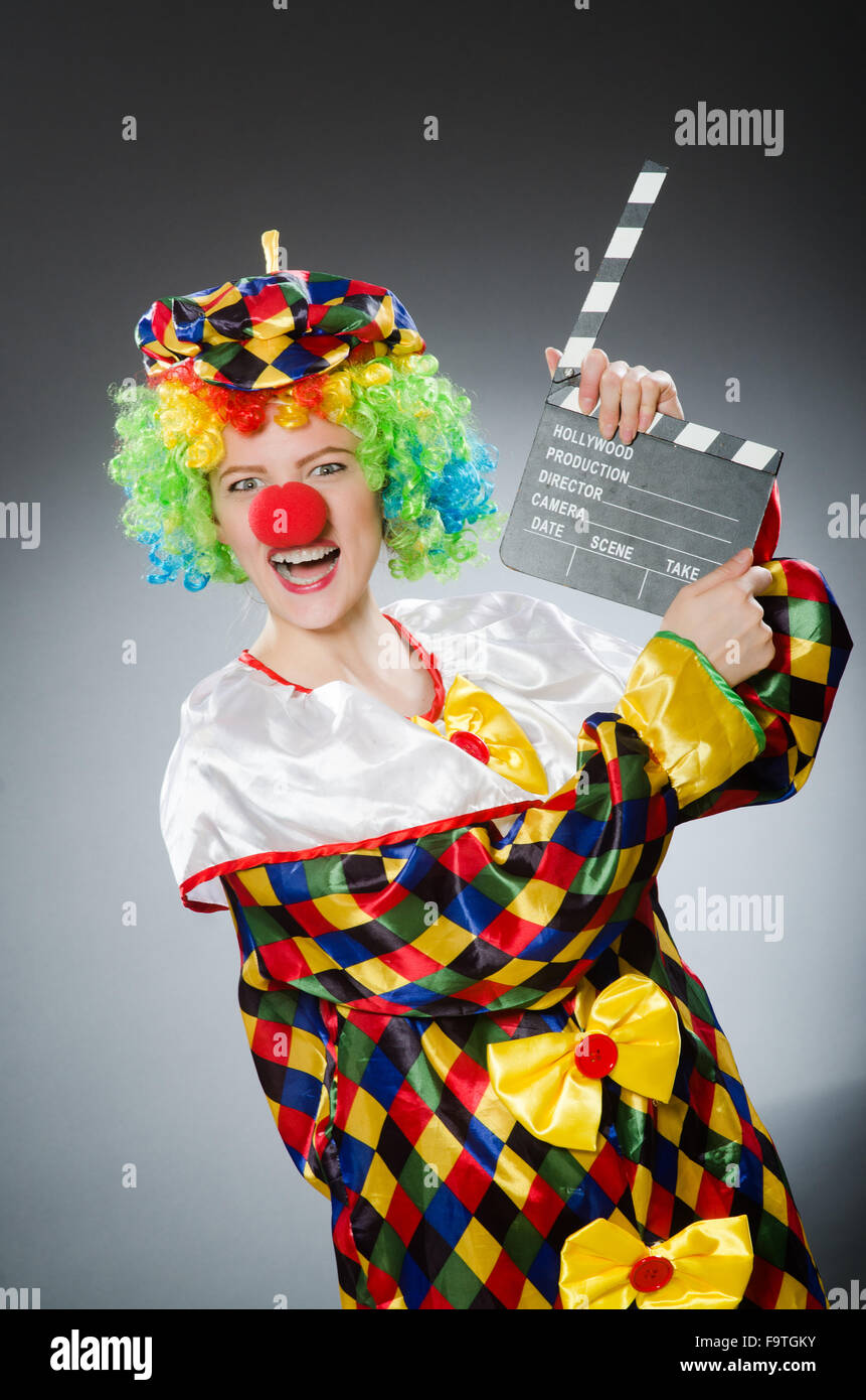 Clown with movie clapper in funny concept Stock Photo - Alamy