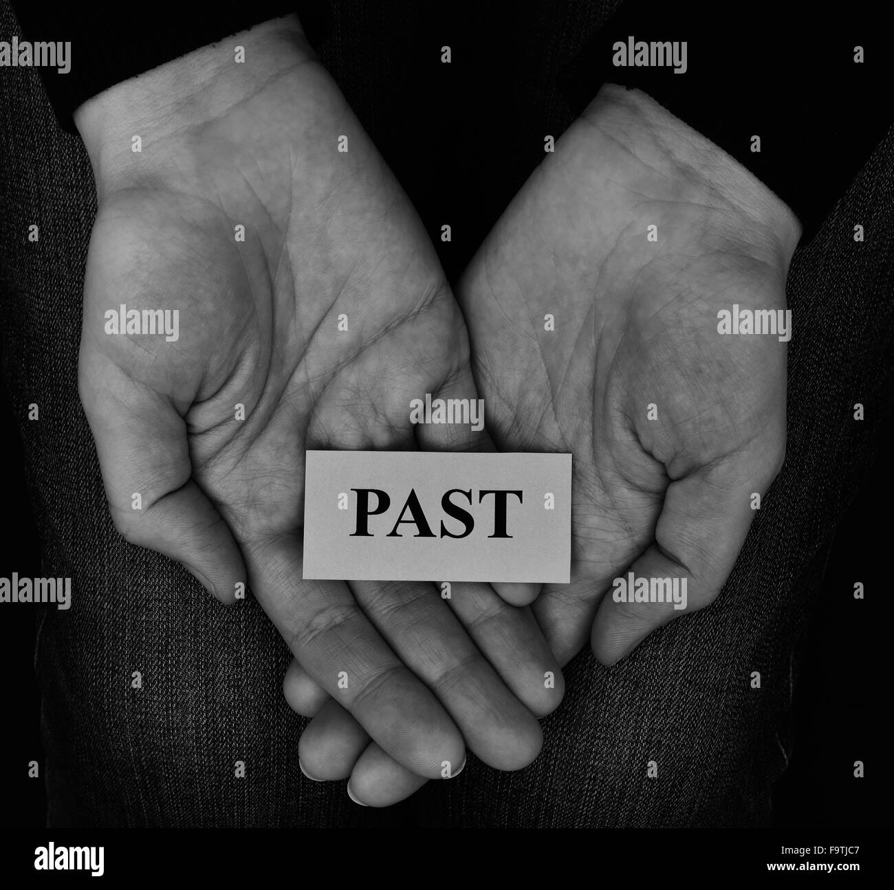 Woman holding word Past in her palms. Black and White image. Close up ...