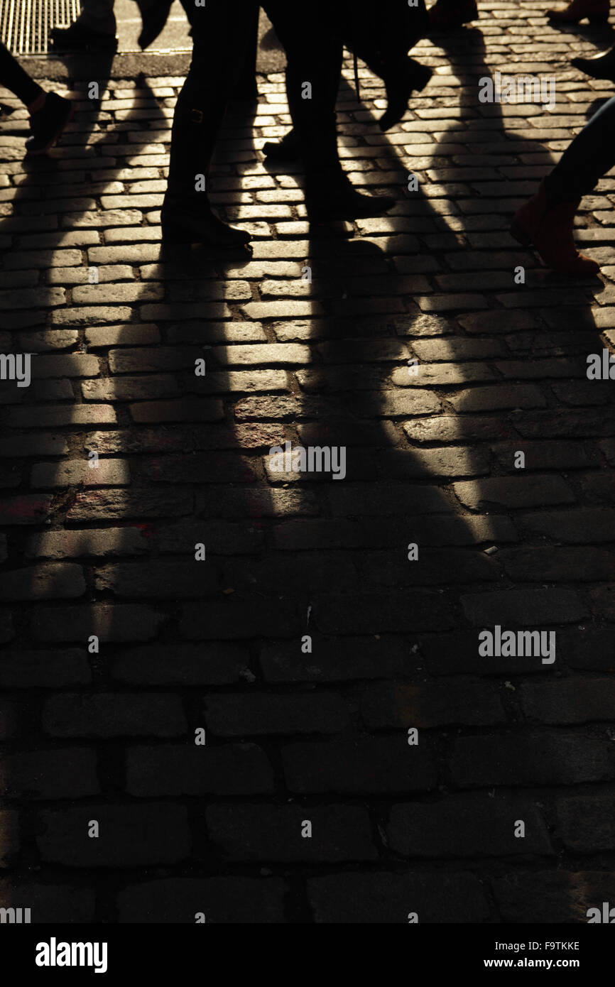 Urban scene cobblestone street legs hi-res stock photography and images ...