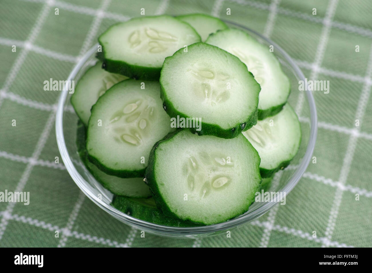 Sliced cucumbers in a glass bowl Stock Photo - Alamy