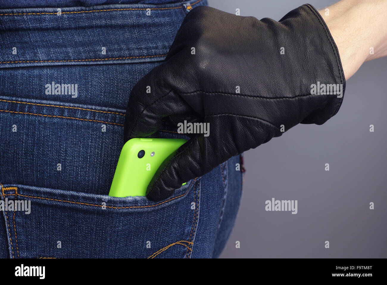 Thief stealing mobile phone from back pocket of a woman Stock Photo - Alamy