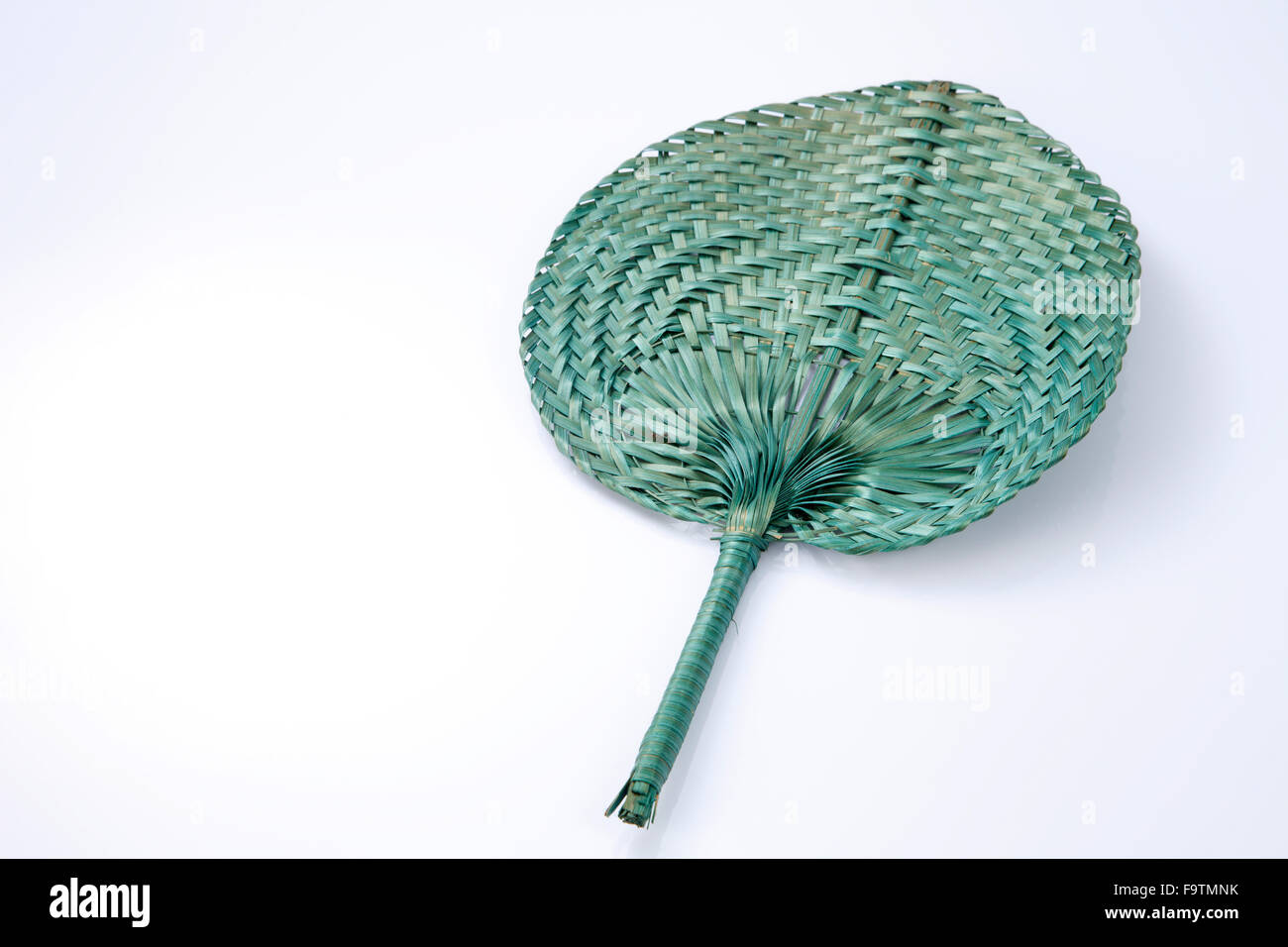Green color native fan made from palm leaves on white background Stock ...