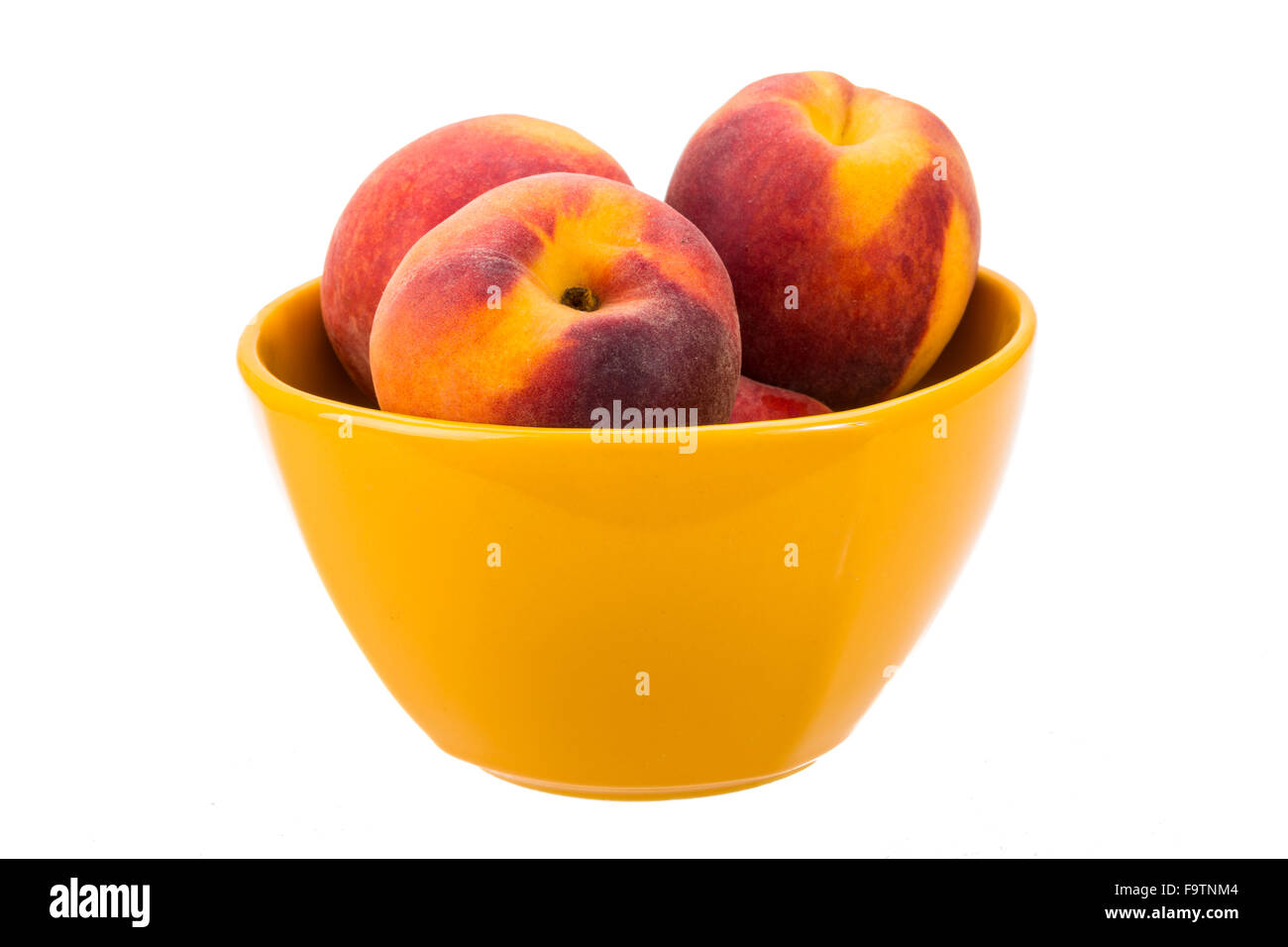 Peaches in the bowl isolated Stock Photo - Alamy