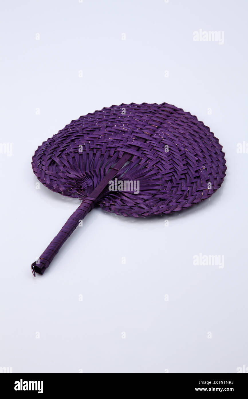 Purple color native fan made from palm leaves on white background Stock ...