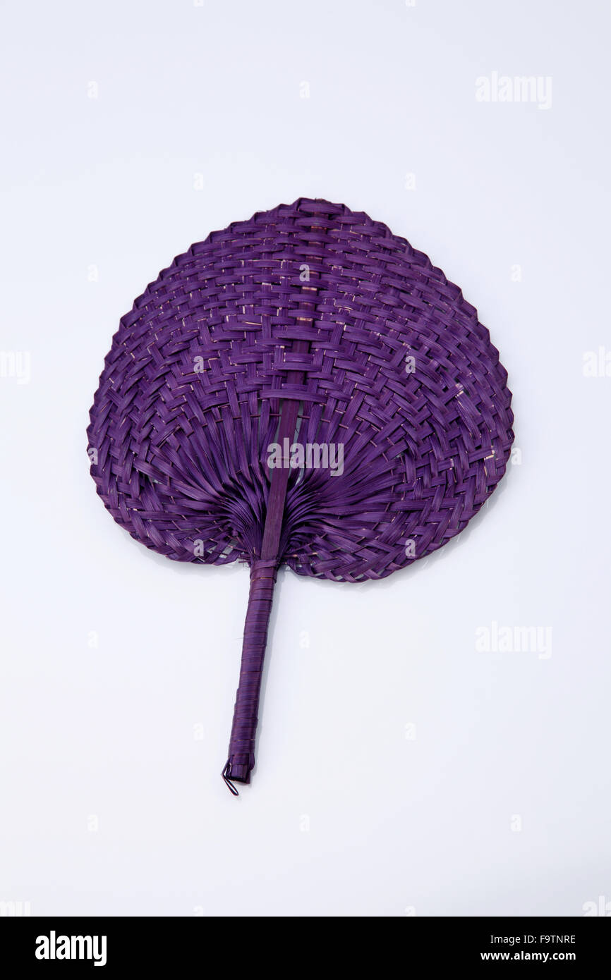 Purple color native fan made from palm leaves on white background Stock ...