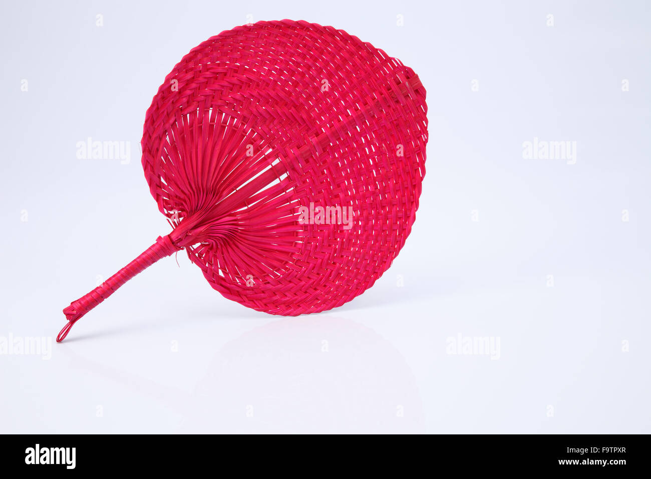 Pink color native fan made from palm leaves on white background Stock ...