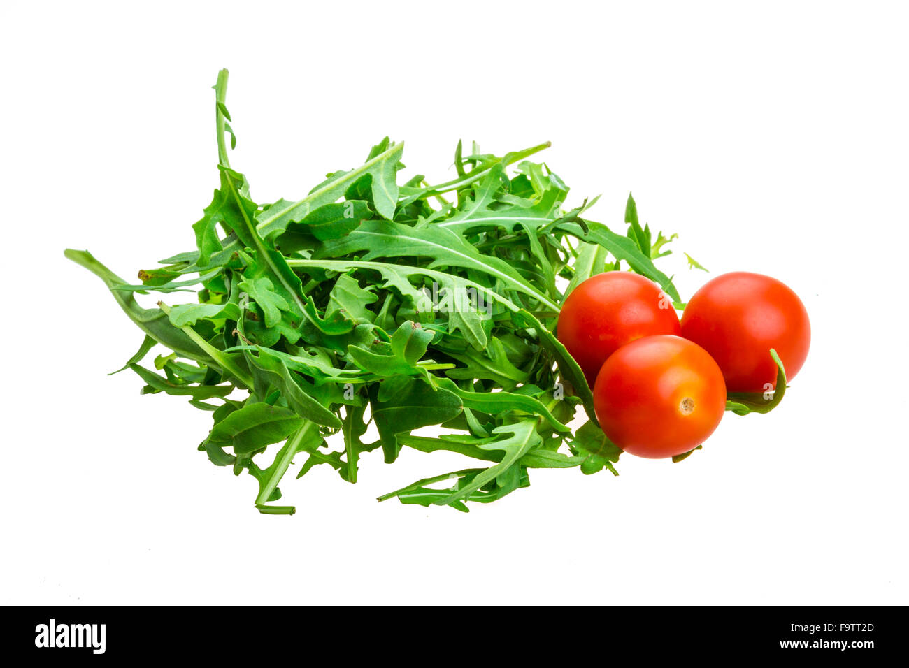 Ruccola with tomato cherry isolated Stock Photo - Alamy