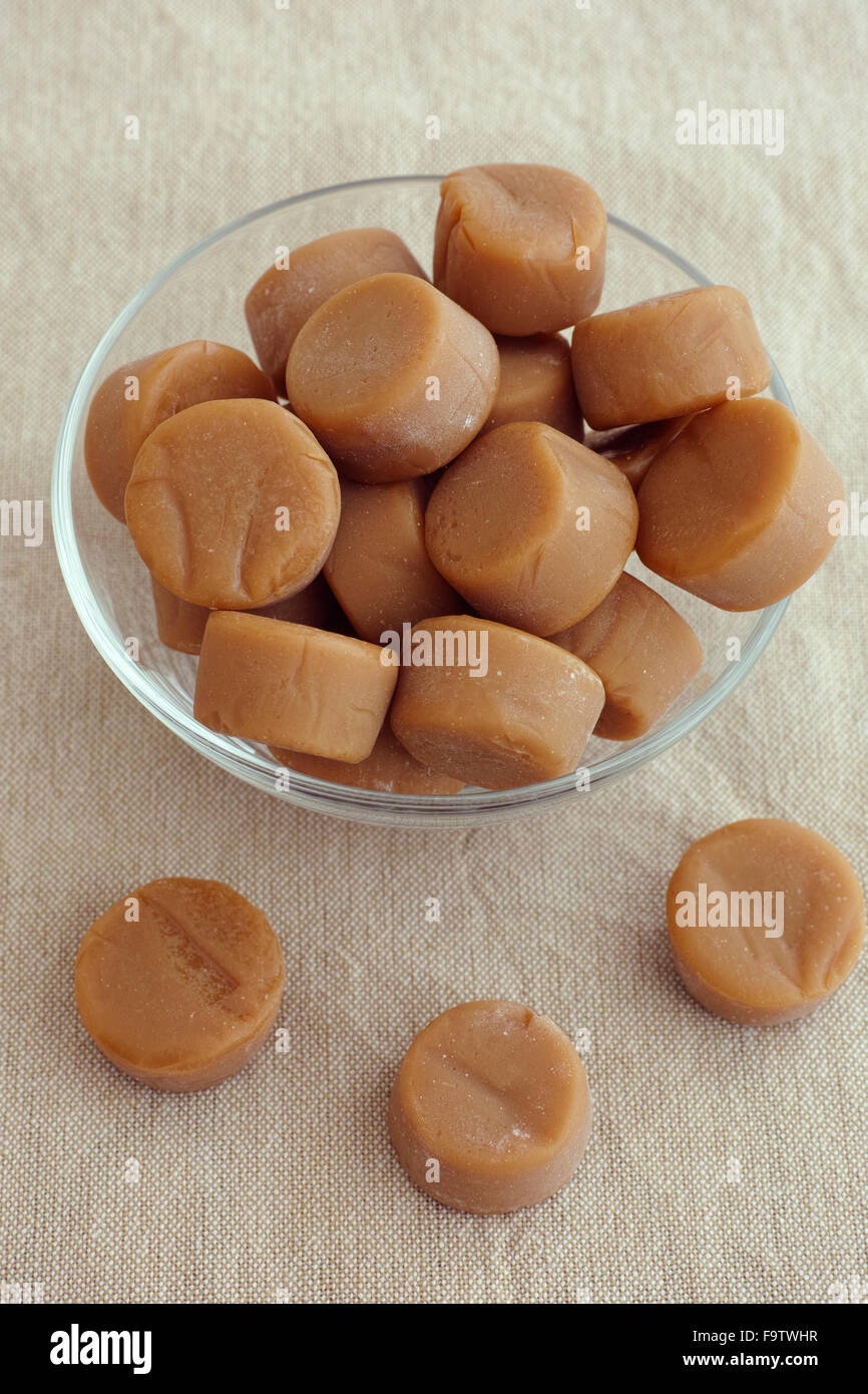 Toffee caramel candies in a glass bowl. Closeup Stock Photo - Alamy