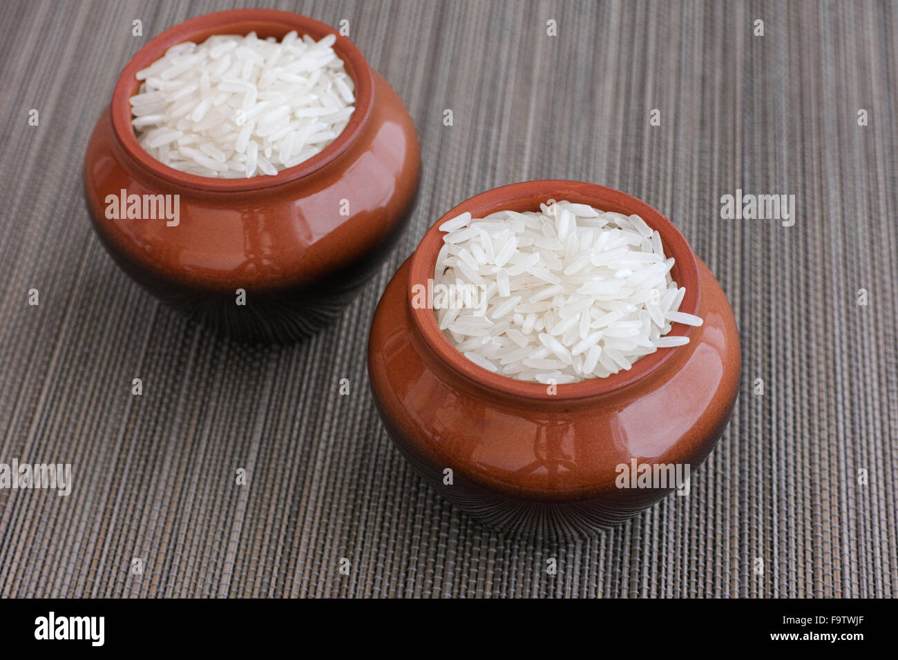 White rice in the clay pots. Close up Stock Photo - Alamy