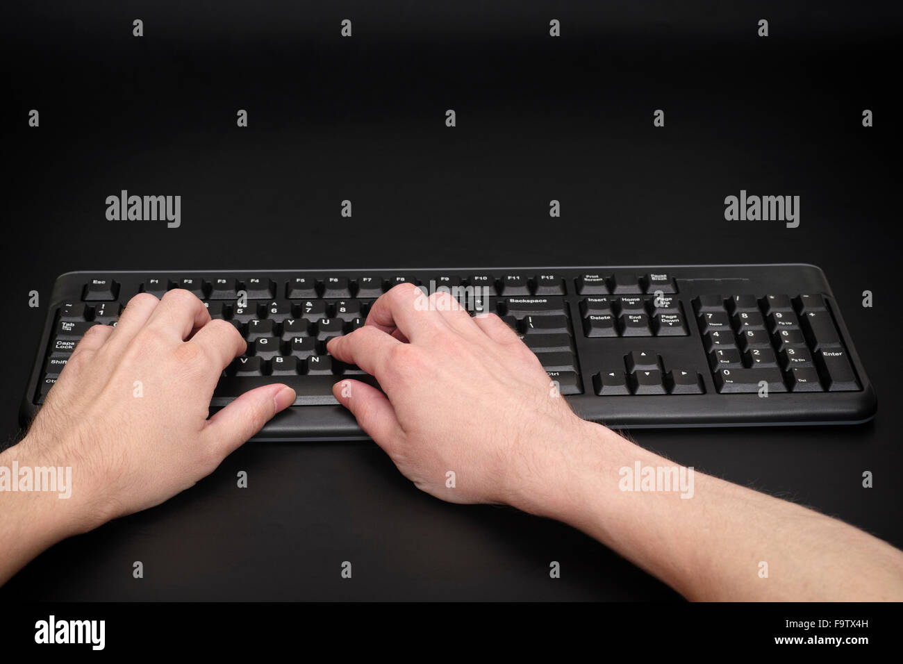 Typing on computer keyboard. Black background Stock Photo - Alamy